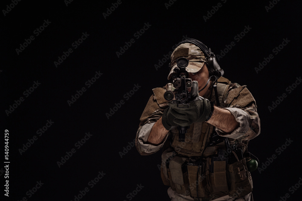 Portrait soldier or private military contractor holding sniper rifle ...