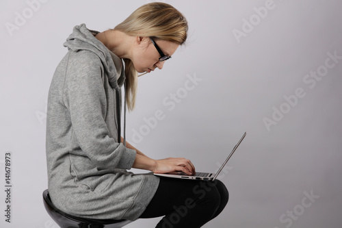 Bad posture effects.Female student using laptop and suffering from back ...