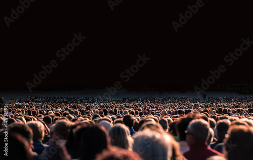 Panoramic photo of large crowd of people. Slow shutter speed motion ...