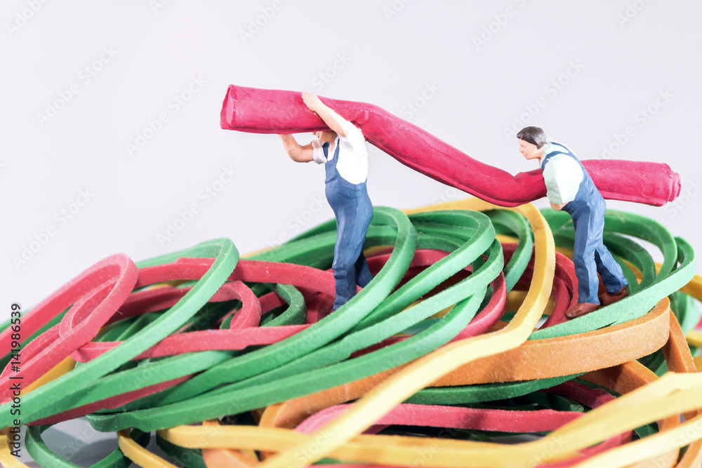 Hard work - two males carrying a rolled up carpet - going to the left ...