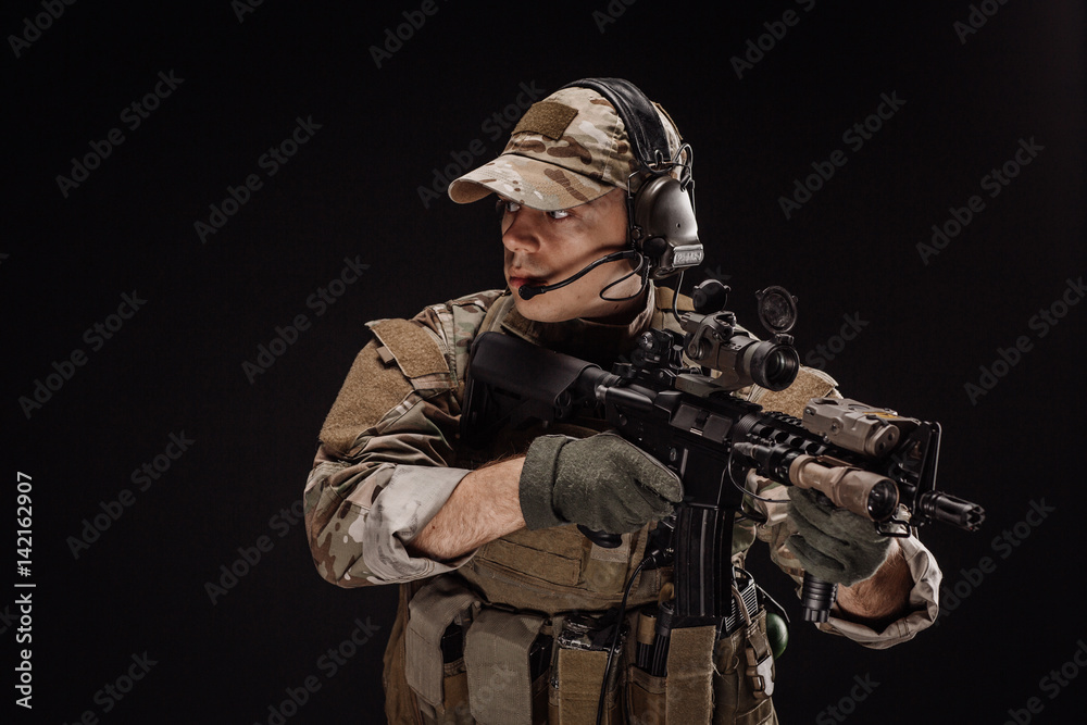 Portrait soldier or private military contractor holding sniper rifle ...