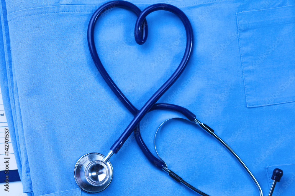 Medical stethoscope twisted in heart shape lying on patient medical ...