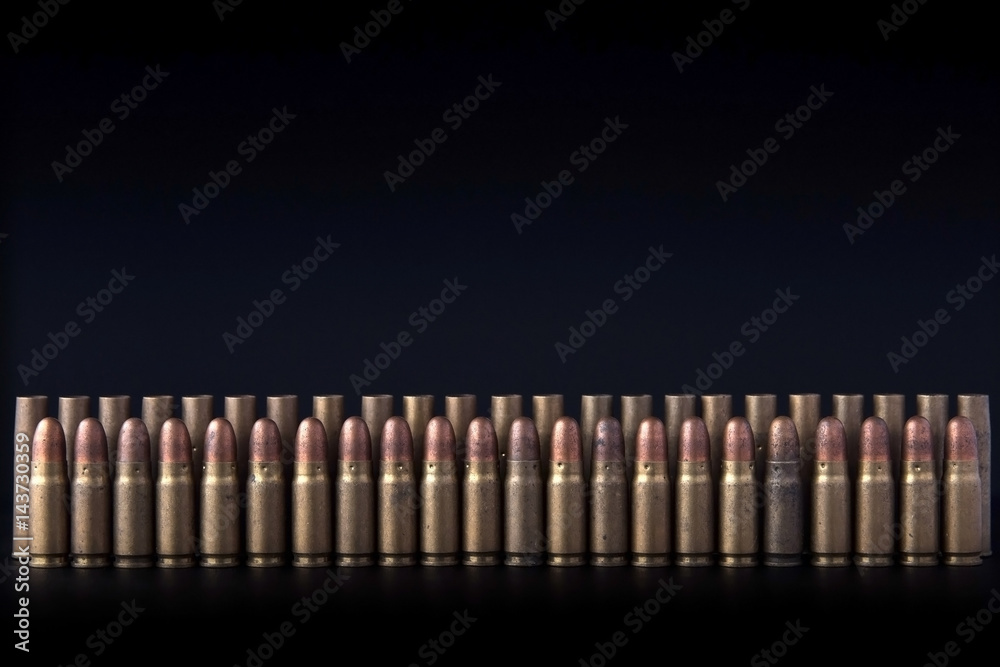 Photo Stock A lot of old gun bullets standing precisely in a row on the ...