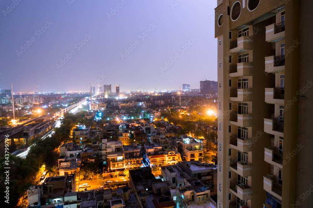 Noida cityscape at night with houses, office, skyscrapers, streets and ...