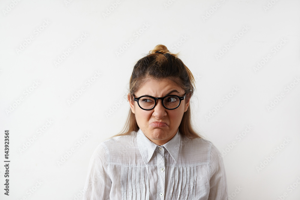 Female student looking offended, holding hands and frowning eyebrows ...