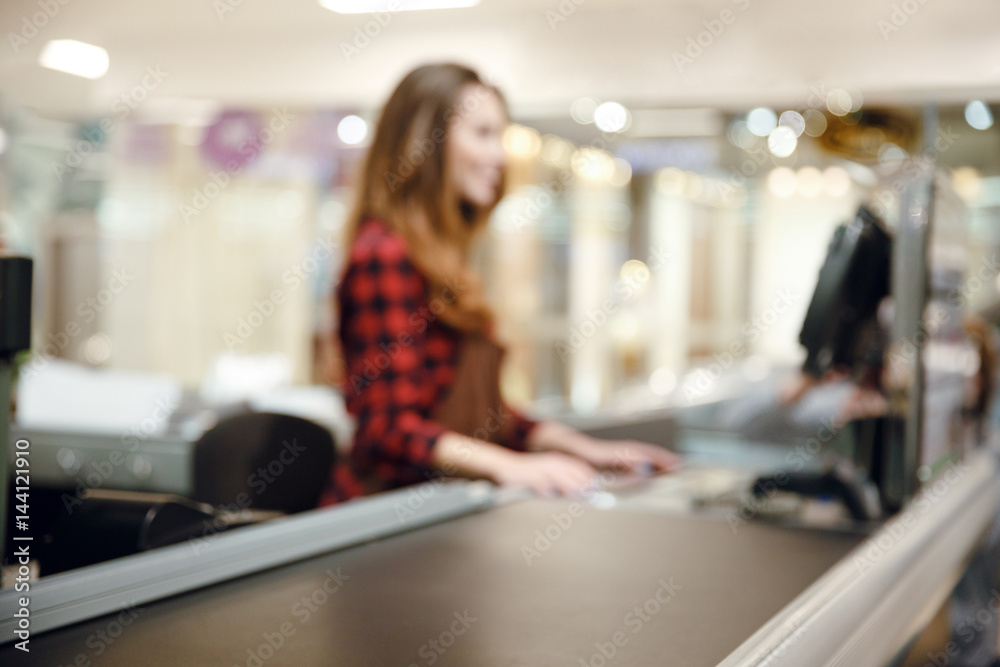 Cashier lady on workspace in supermarket shop. Focus on desk. Stock ...