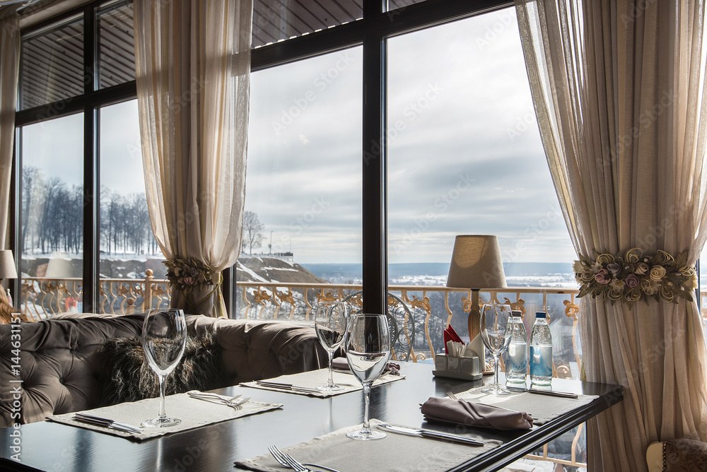 Table with a bar in the restaurant with panoramic windows. Elegant ...