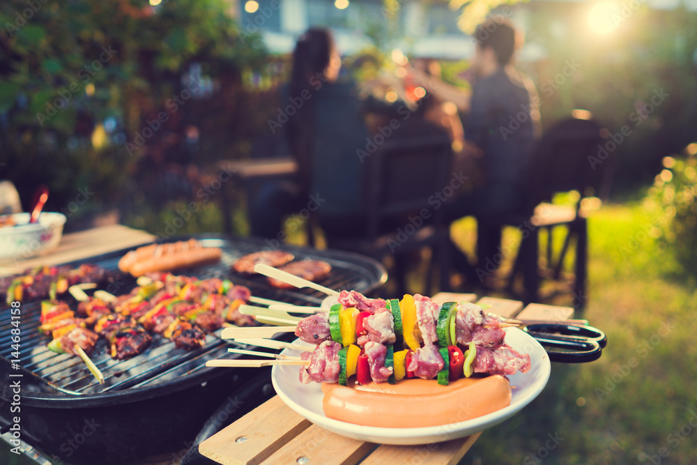 Dinner party, barbecue and roast pork at night Stock Photo | Adobe Stock