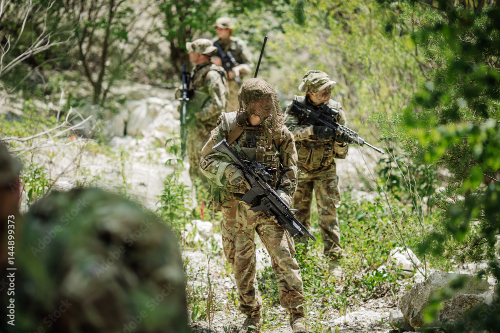Special forces soldiers with weapon take part in military maneuver. war ...