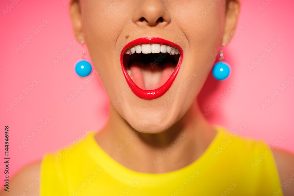 Scream and shout! Close up of opened female mouth. Bright red lips ...