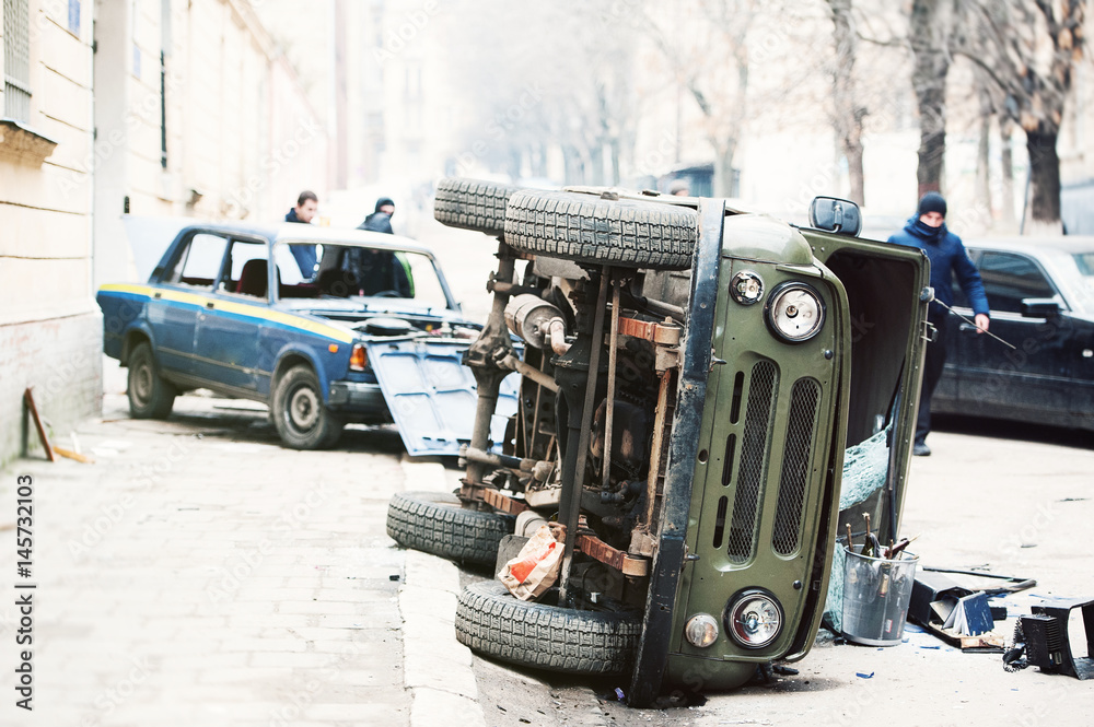 cars destroyed by protesters during riot. Two police cars destroyed ...