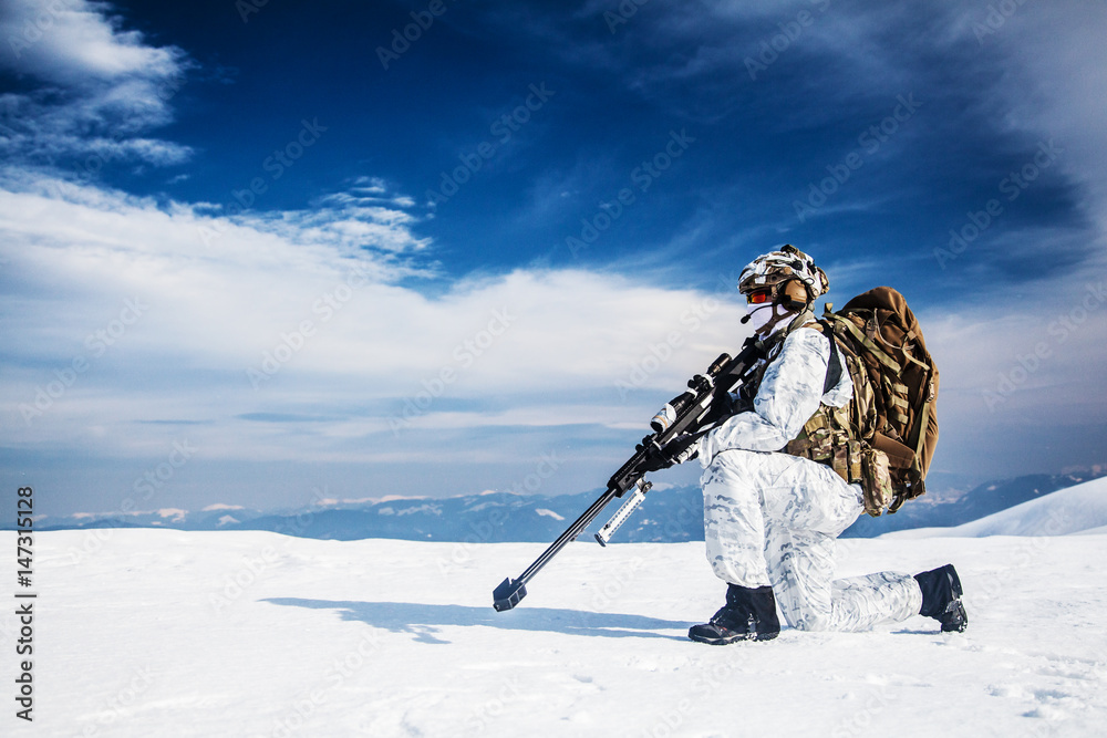 Army soldier with Sniper rifle in action in the Arctic. He wears chest ...