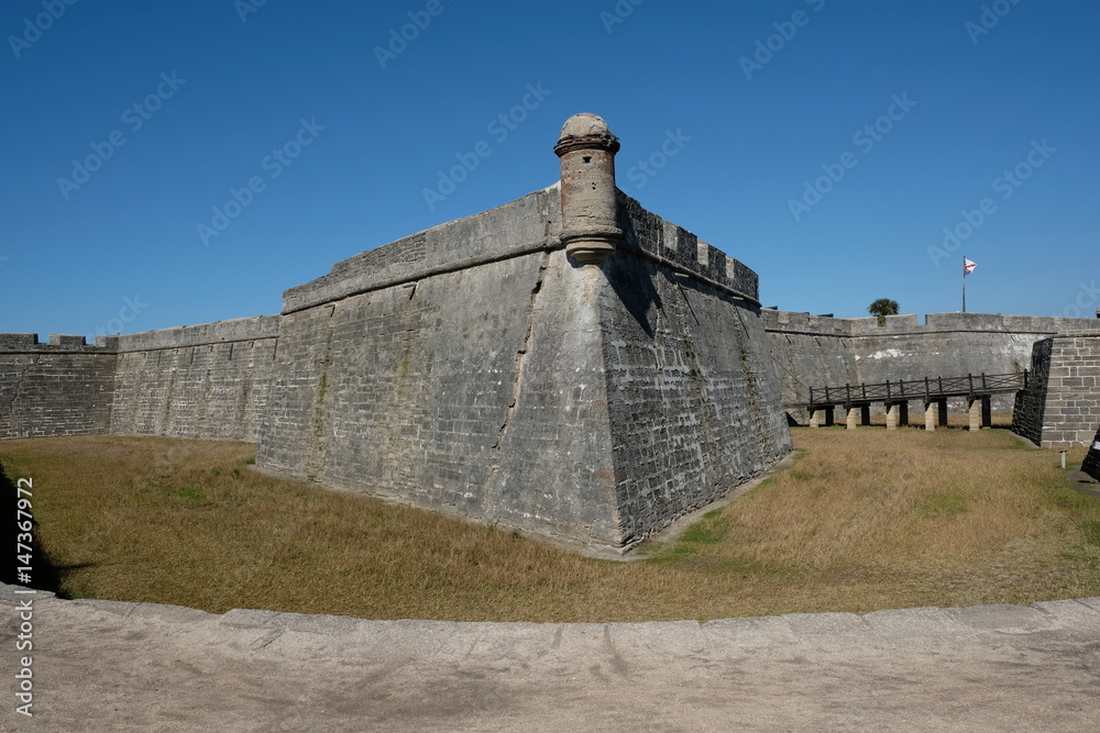 Corner of Castillo de San Marcos, green grass and former moat of ...