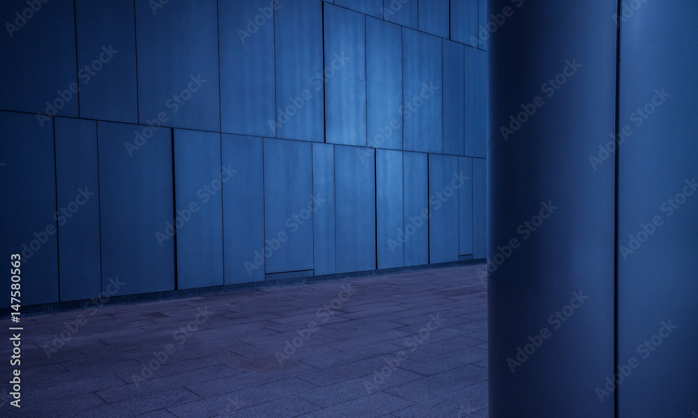 Brushed metal tiled panels wall and column/pillar background in modern ...