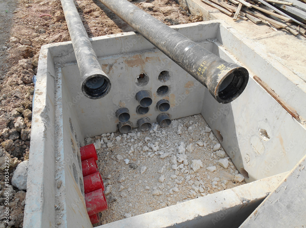 Precast concrete manhole for underground utility services under ...