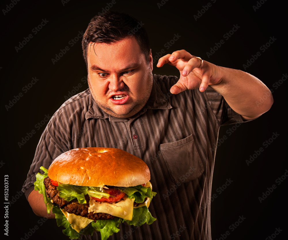 Diet failure of fat man eating fast food hamberger. Aggressive ...