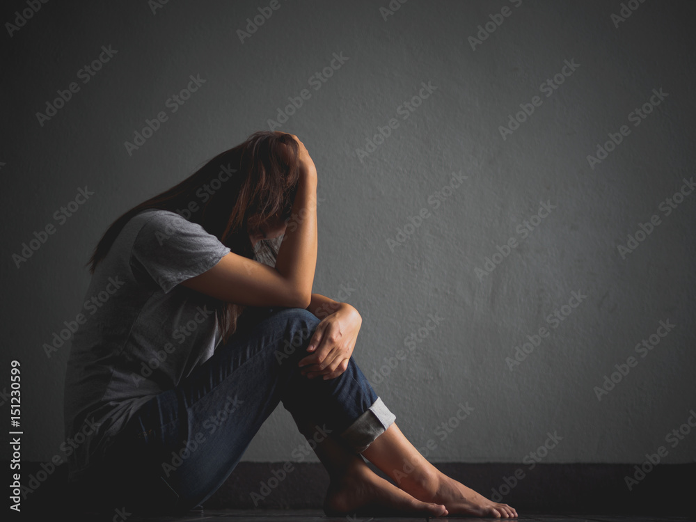 sad woman hug her knee and cry. Sad woman sitting alone in a empty room ...
