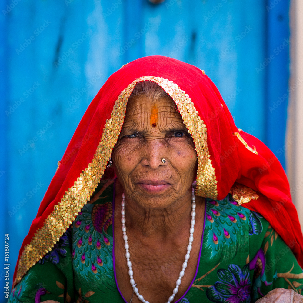 Portrait of an Indian women on blue background in a rural setting Stock ...