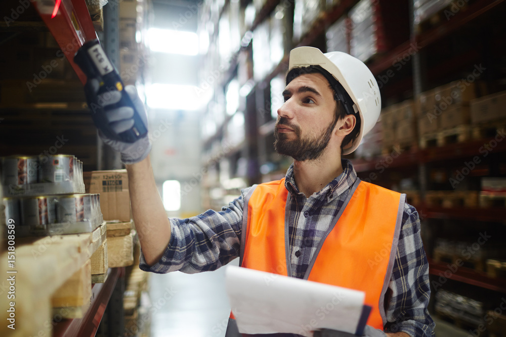 Dispatcher of warehouse scanning packed goods Stock Photo | Adobe Stock
