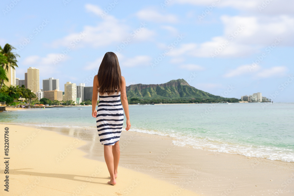 Waikiki beach vacation woman relaxing walking on sand at sunset ...