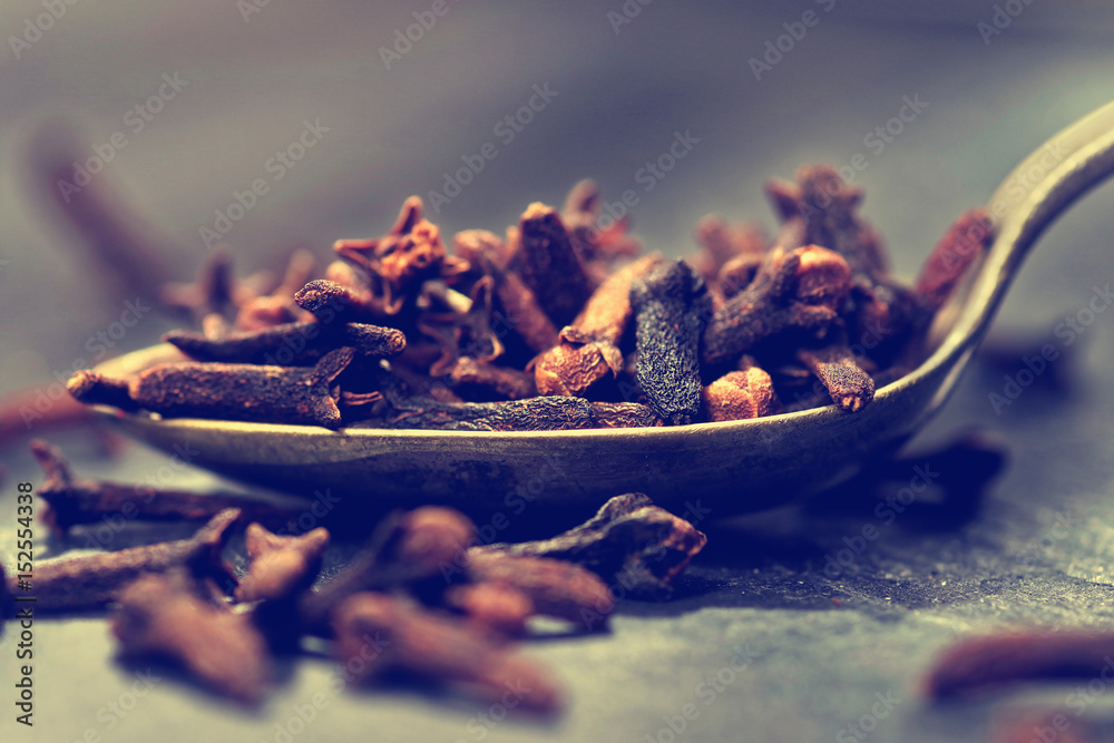 Cloves. Spice in spoon on texture background Stock Photo | Adobe Stock