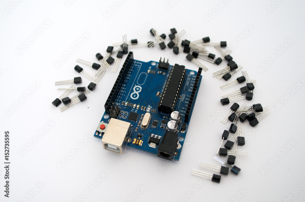 Arduino and around transistors lined up on a white background Stock ...