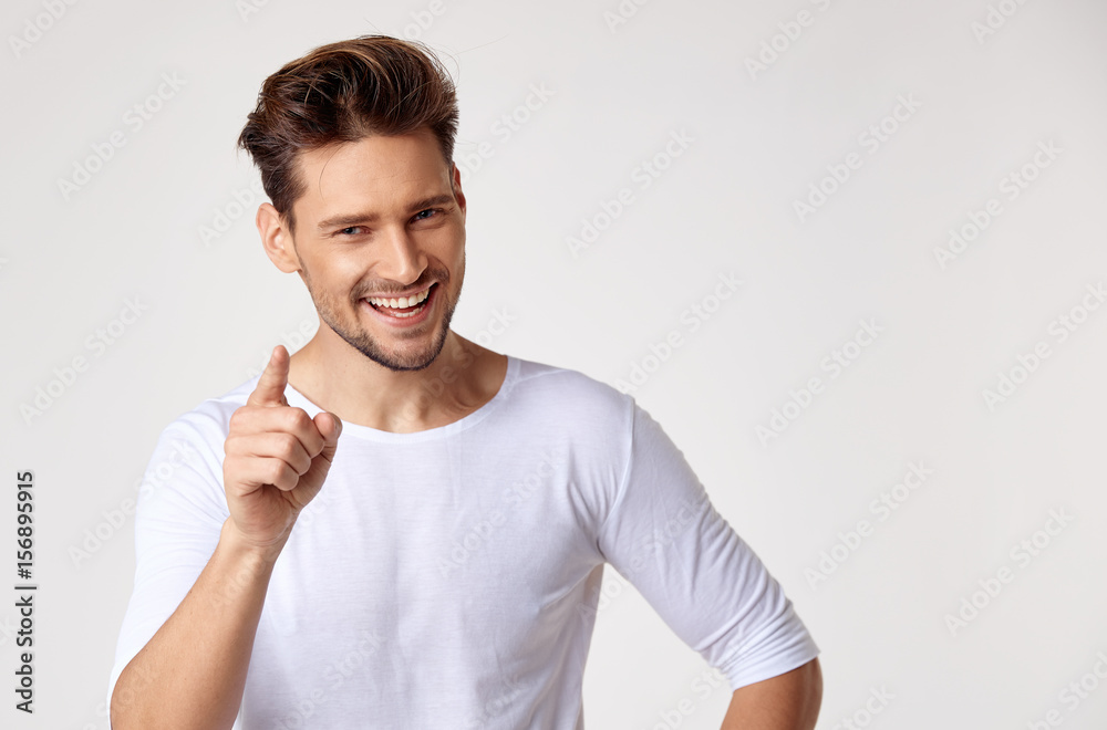Handsome young man pointing something Stock Photo | Adobe Stock