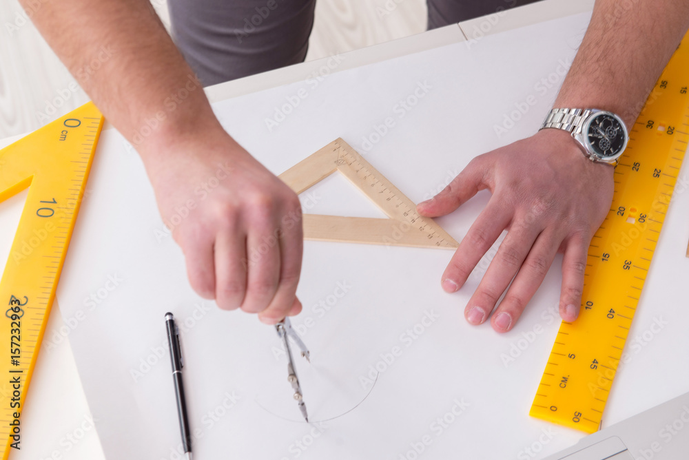 Male engineer working on drawings and blueprints Stock Photo | Adobe Stock