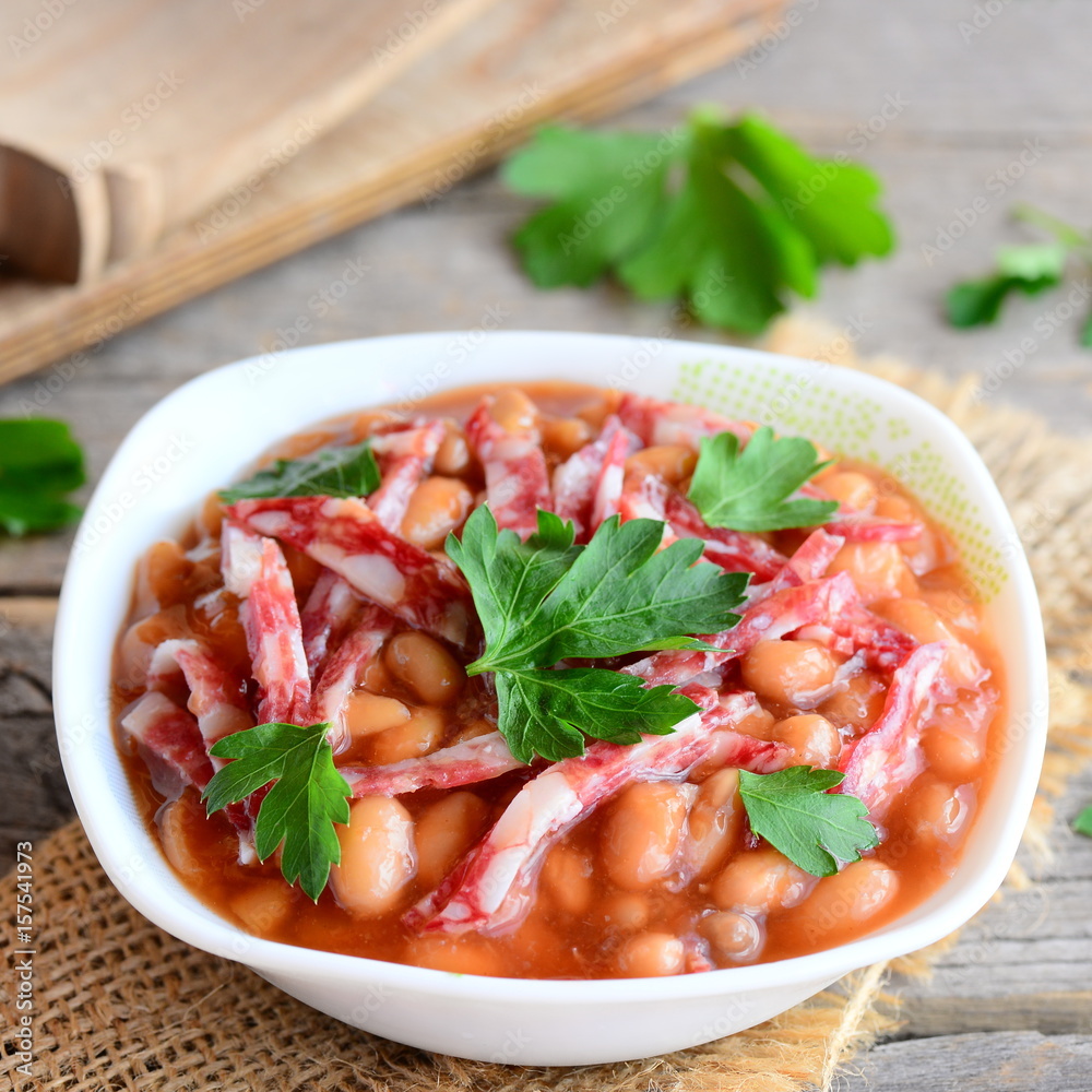 Red bean stew with smoked sausage, tomato sauce and fresh parsley in a ...