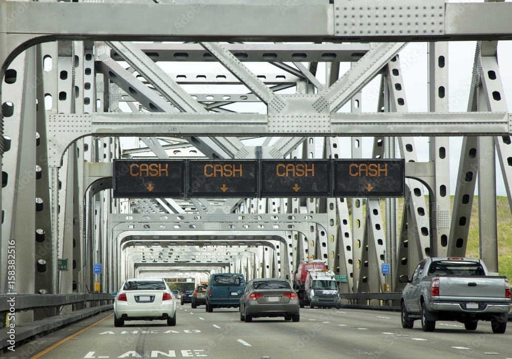 CASH ONLY toll information sign attached to truss bridge with traffic ...