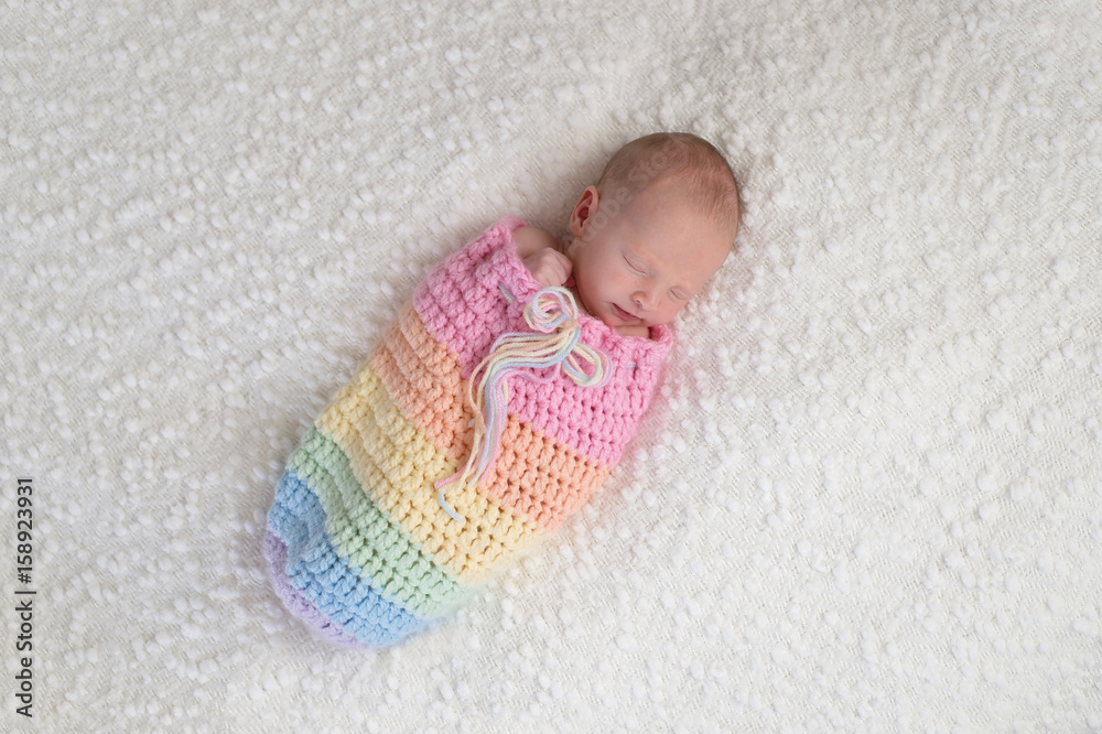 Newborn Baby Girl in a Rainbow Colored Pouch Stock Photo | Adobe Stock