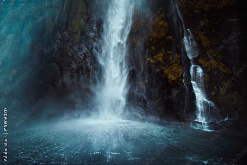 The rushing waterfall splashes into a cold New Zealand sound Stock ...