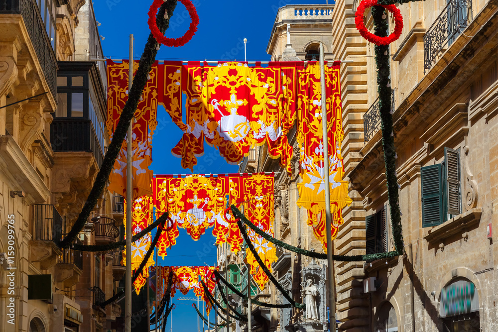 Festively decorated street with banners for St Augustine Feast in the ...