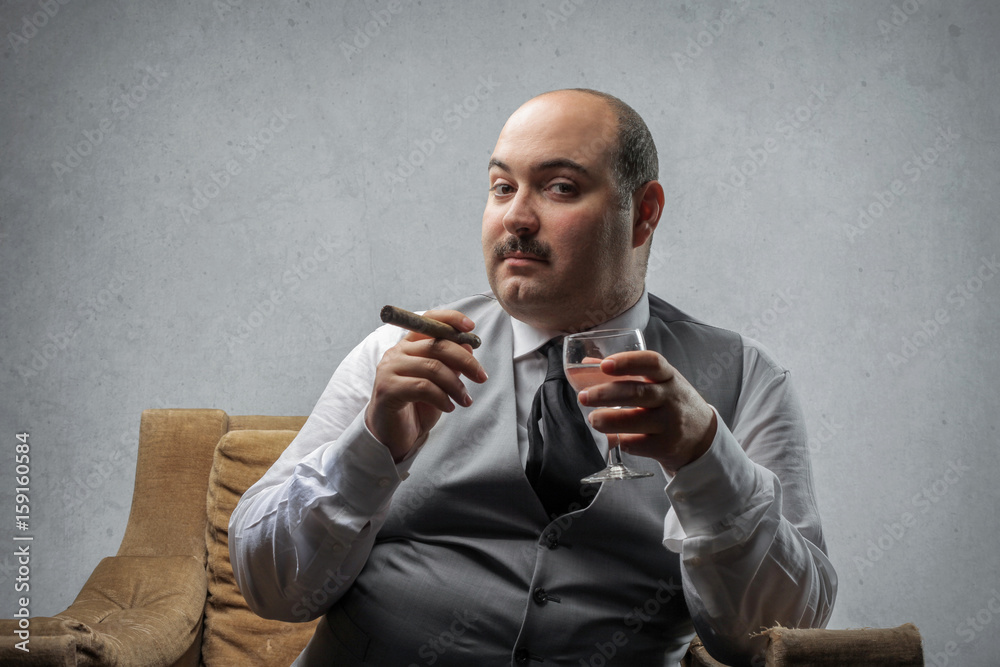 Rich man smoking a cigar Stock Photo | Adobe Stock