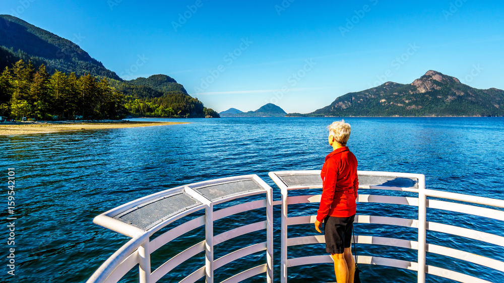Foto de Stock Senior woman enjoying the view of Howe Sound and ...