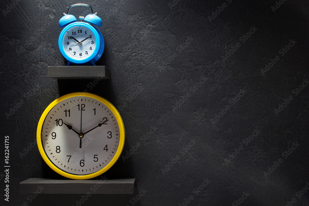 wall and alarm clock at black background texture Stock Photo | Adobe Stock