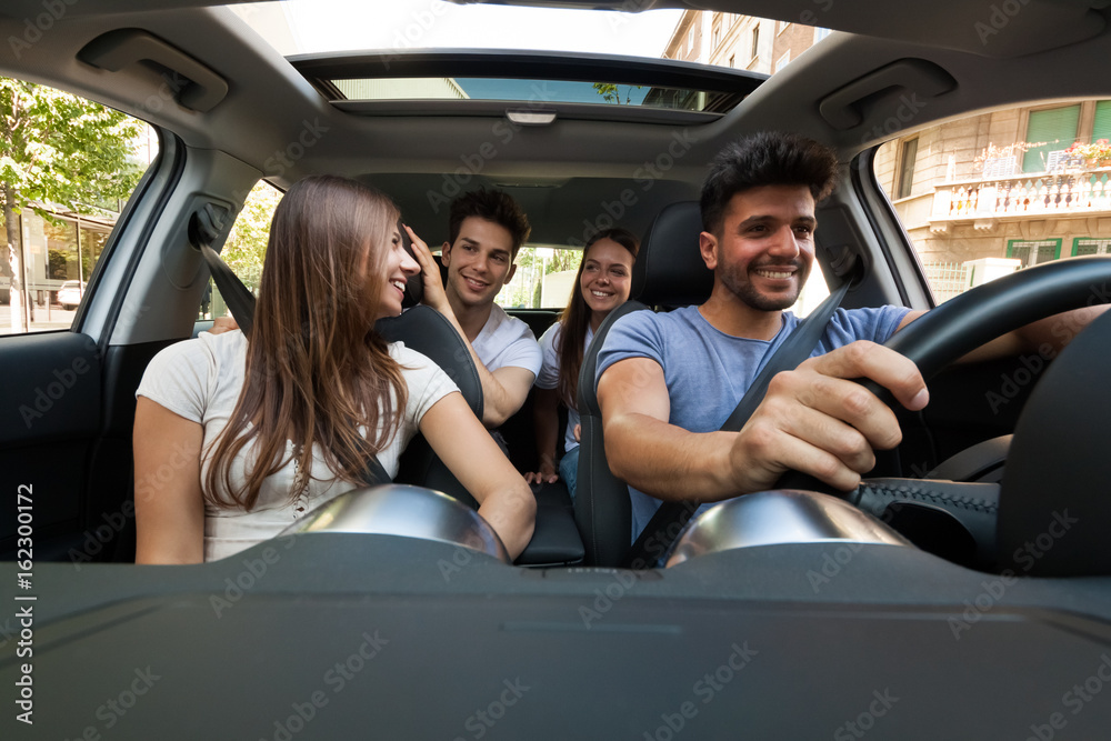 Group of friends on a car Stock Photo | Adobe Stock