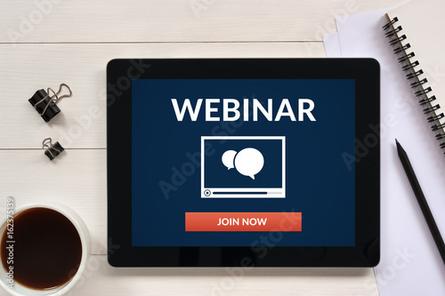 Webinar concept on tablet screen with office objects on white wooden ...