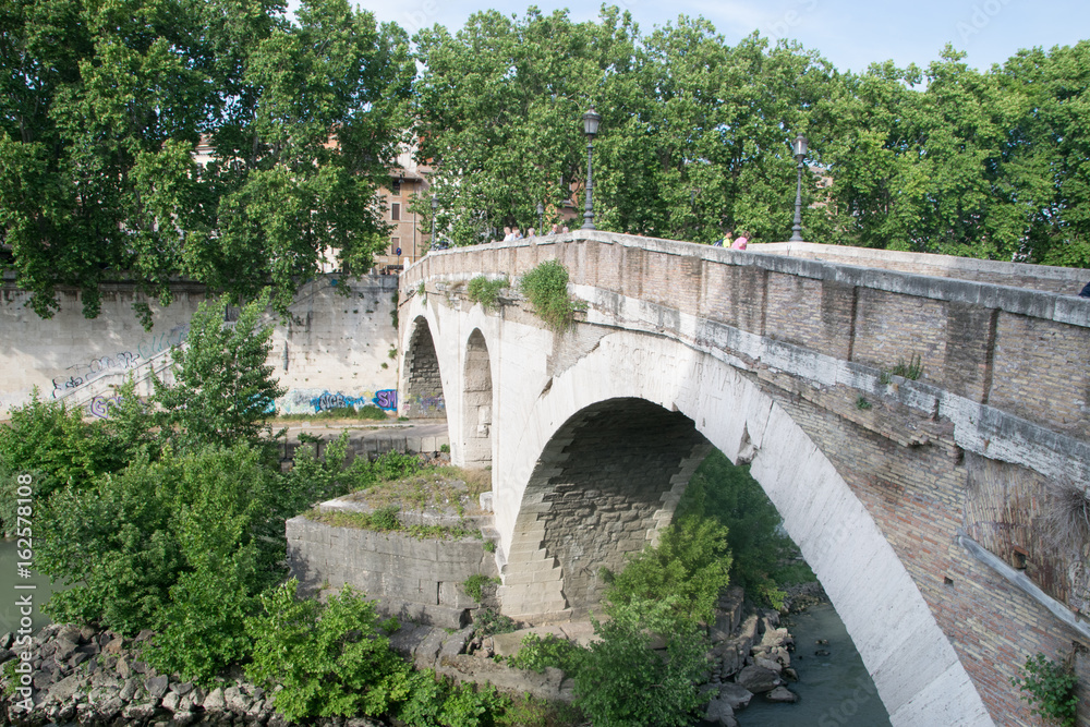 Ponte Fabricio and Isola Tiberina in Rome, Italy. Fabricius Bridge is ...