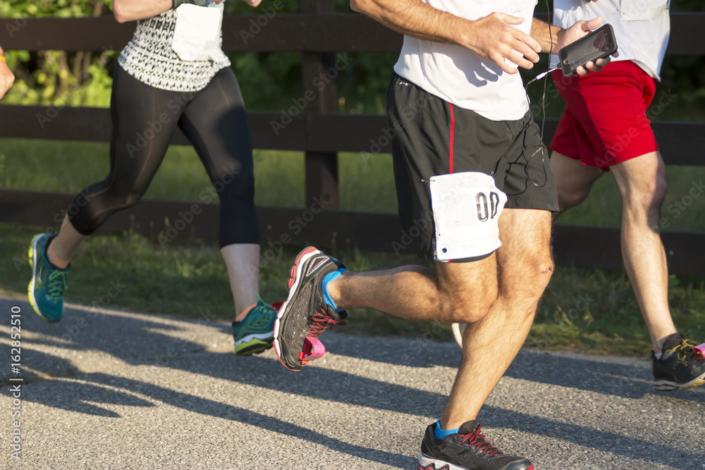 Running a race with a cell phone for music Stock Photo | Adobe Stock