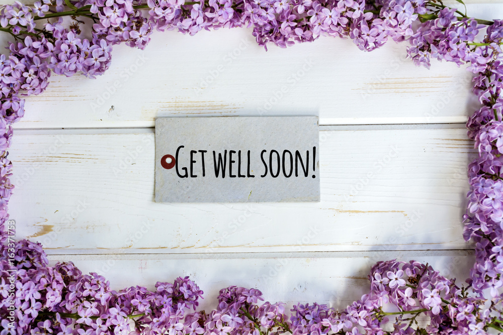 Beautiful purple lilac flower frame with get well soon sign on white ...