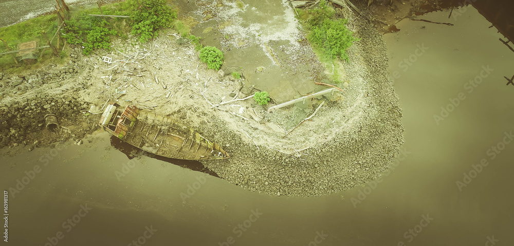 Shipwreck lying on its side against the rocks Stock Photo | Adobe Stock