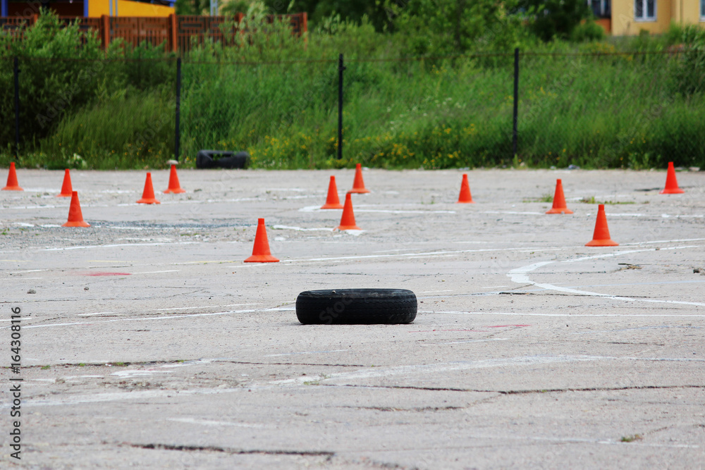 many plastic signaling traffic cones and Rubber tires from wheels are ...