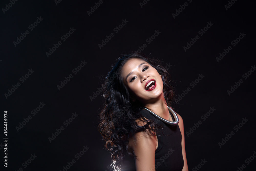 low key portrait of tan skin asian slim healthy woman in black background Stock Photo | Adobe Stock