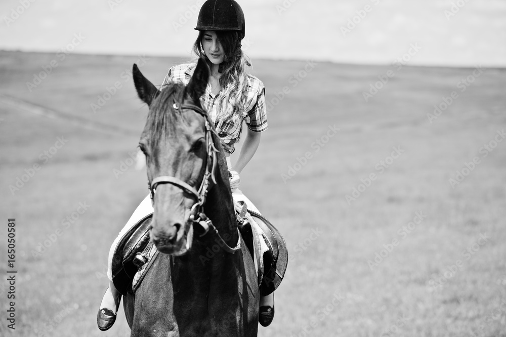 Young pretty girl riding a horse on a field at sunny day. Stock Photo ...