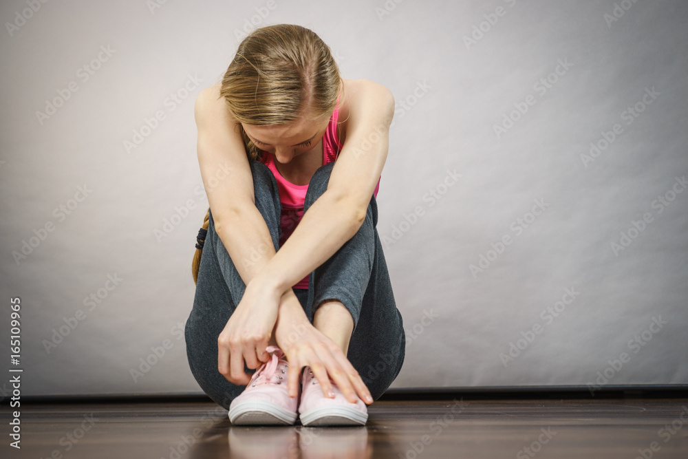 Sad depressed young teenage girl sitting by wall Stock Photo | Adobe Stock
