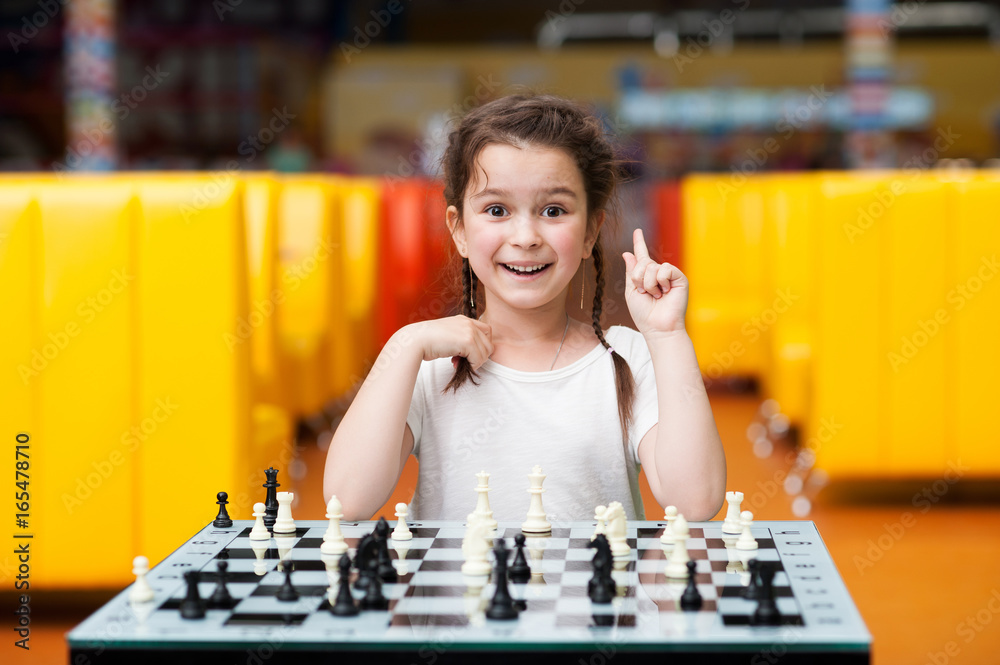 Little girl playing chess Stock Photo | Adobe Stock