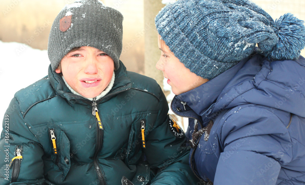 teenager siblings boy and girl in snow winter park sister sooth her crying brother Stock Photo ...