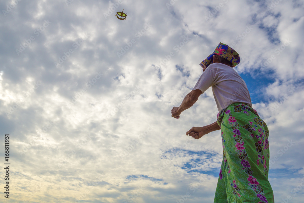 Unidentified man is playing the traditional moon kite or locally known ...
