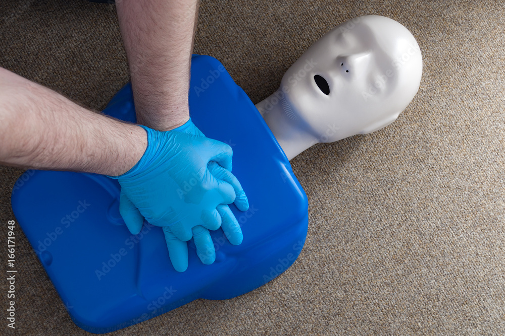 First aid and cardiopulmonary resuscitation training on a CPR dummy, a ...
